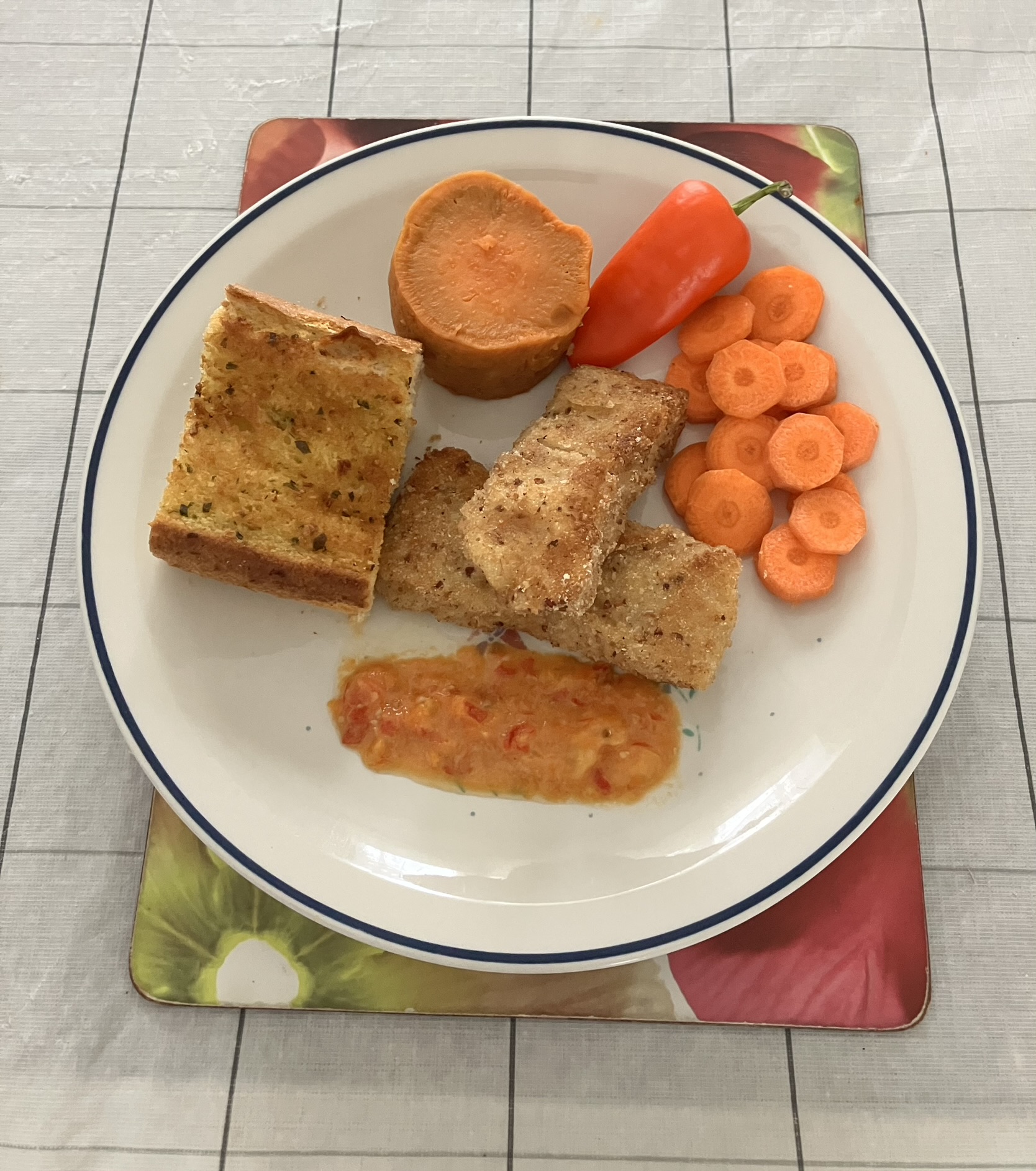 Pan cooked fish carrot sweet potato and garlic bread with tomato puree ...