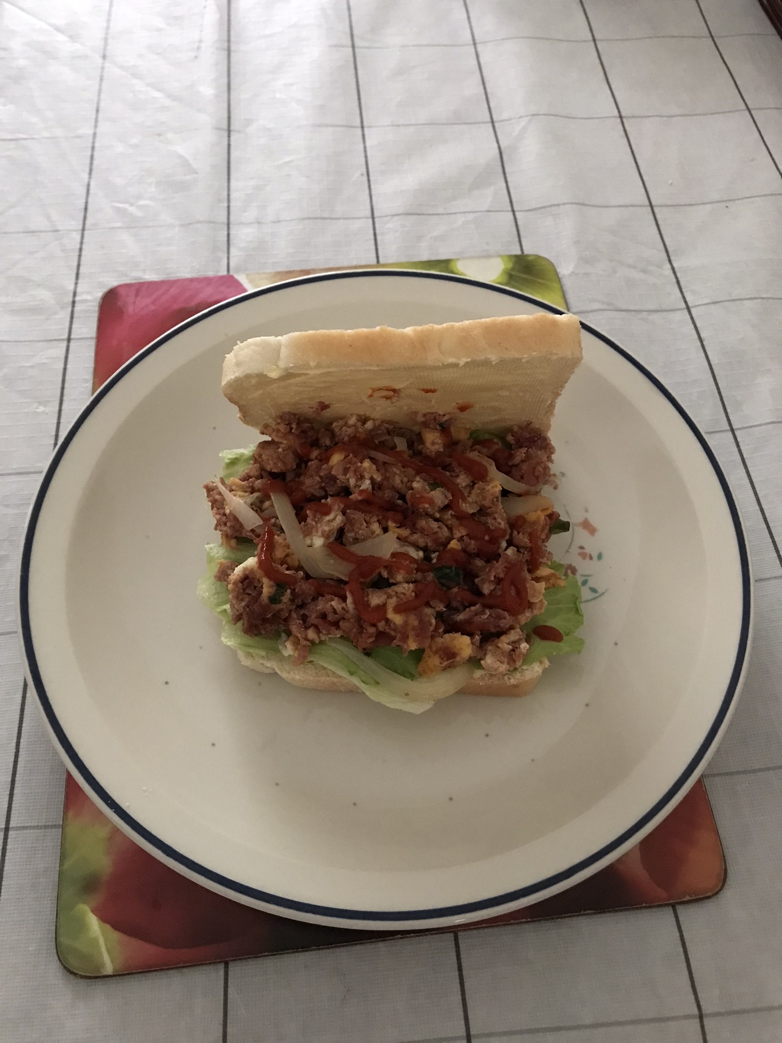 Corned beef egg onion cos lettuce on bread with chili sauce ...